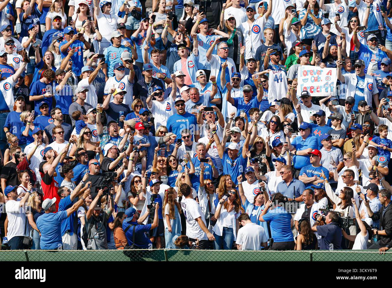 Former Chicago Cubs player Anthony Rizzo sings from the bleachers with ...