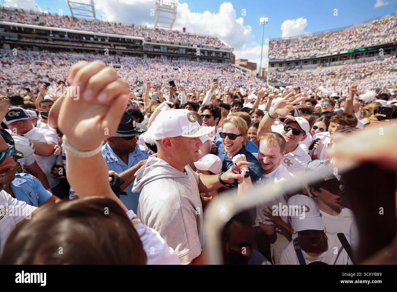 Georgia Tech head football coach Brent Key, center, walks off the field ...