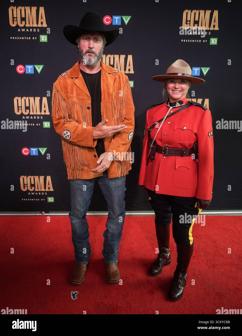 Host Tom Green poses with RCMP Sgt. Laura Pollock as he arrives on the ...