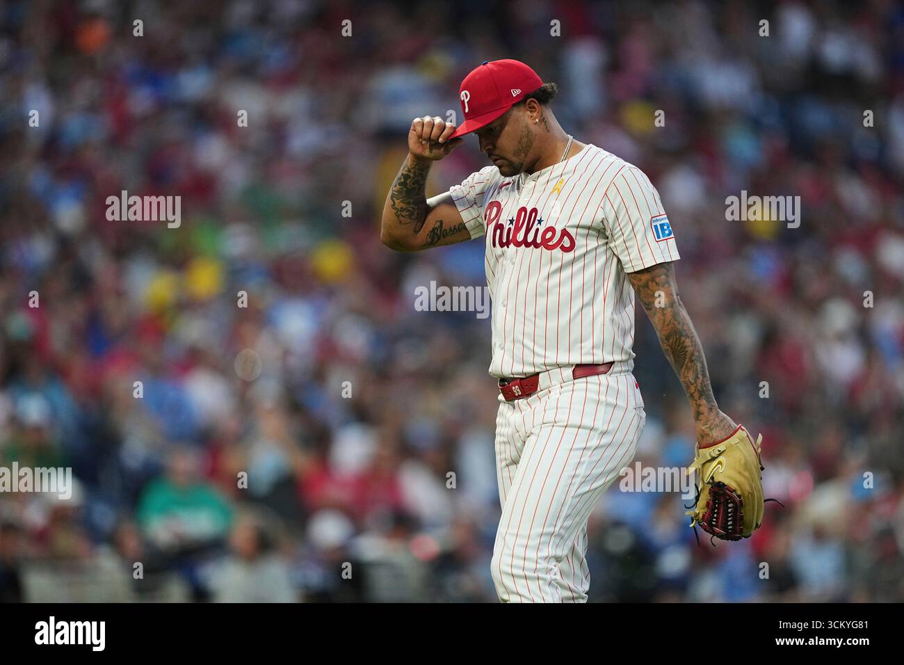 Philadelphia Phillies' Taijuan Walker walks off the field during the third inning of a baseball ...