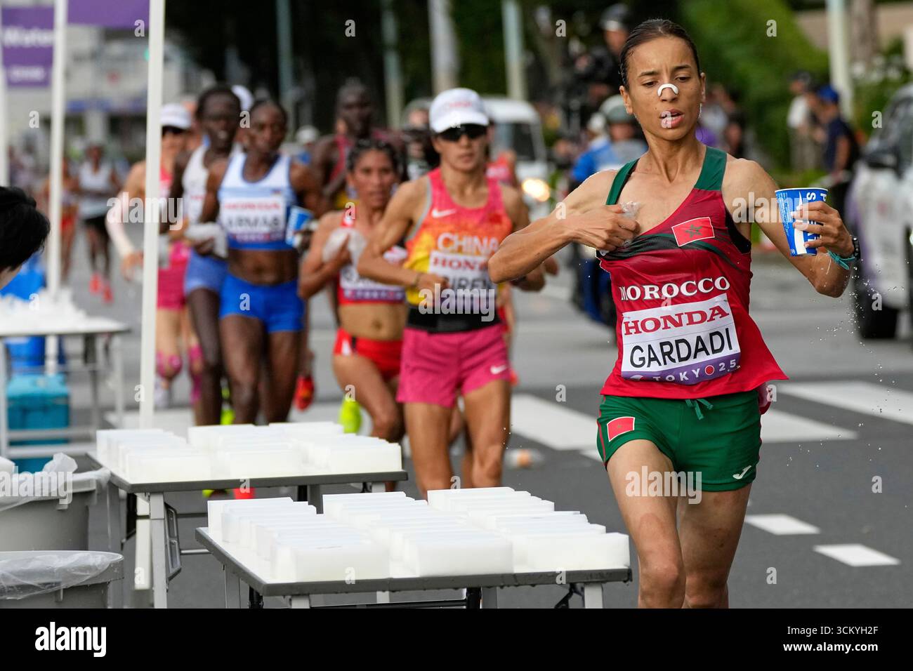 Morocco's Fatima Ezzahra Gardadi takes refreshments at a drinks station in the women's marathon ...