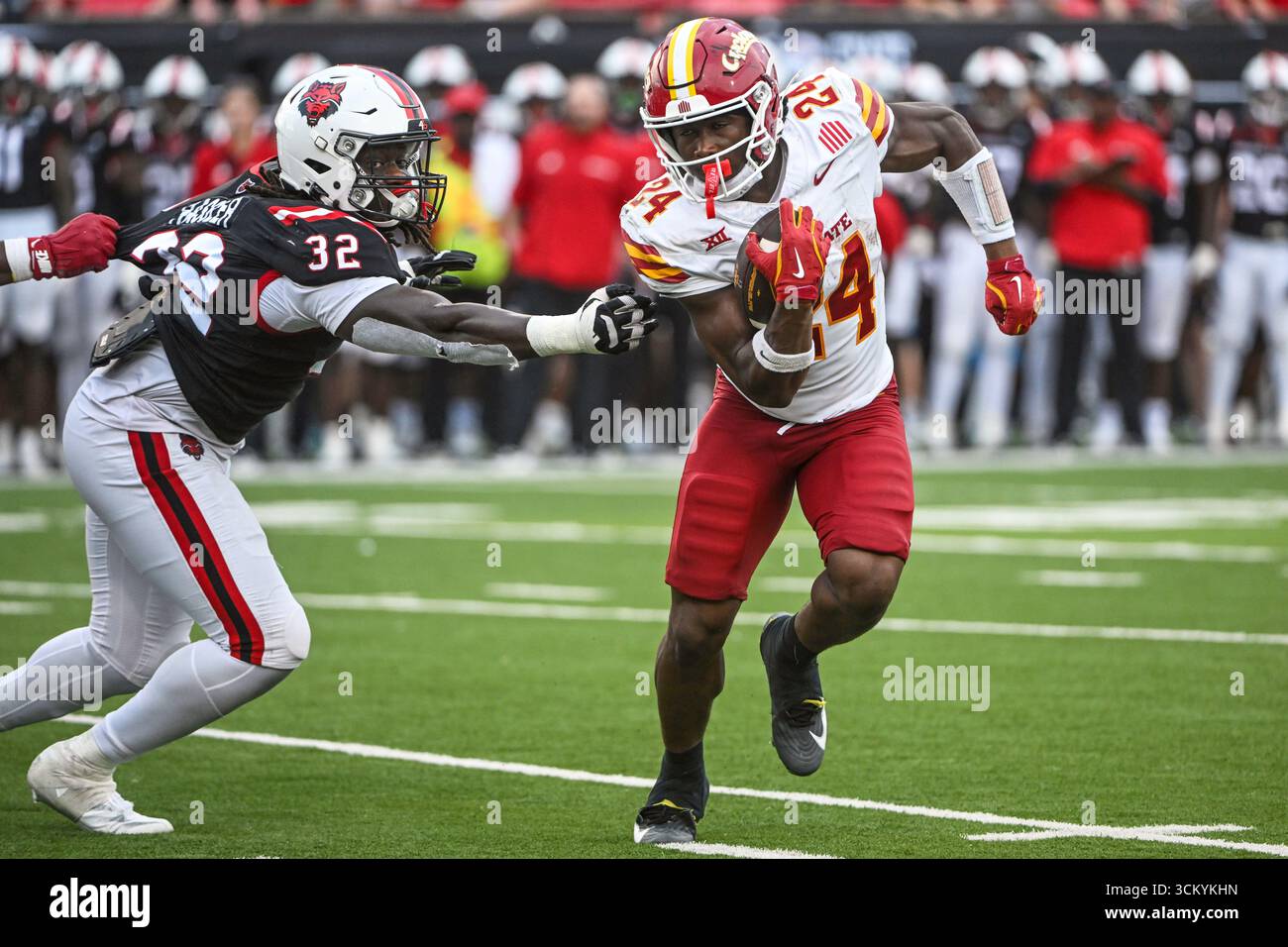 Iowa State running back Abu Sama III (24) tries to escape Arkansas ...