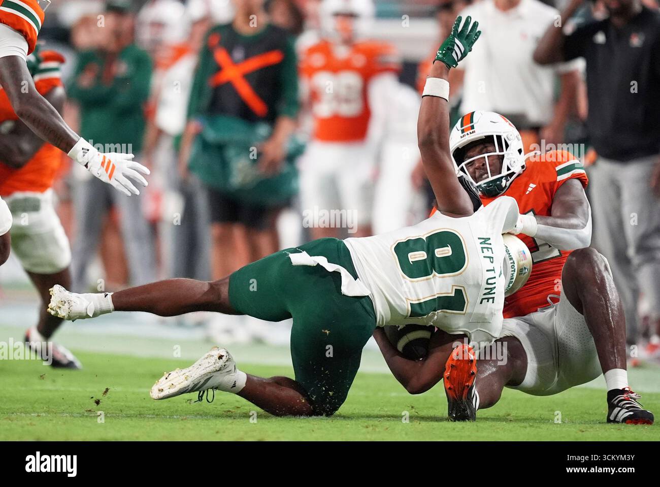Miami linebacker Chase Smith brings down South Florida wide receiver ...