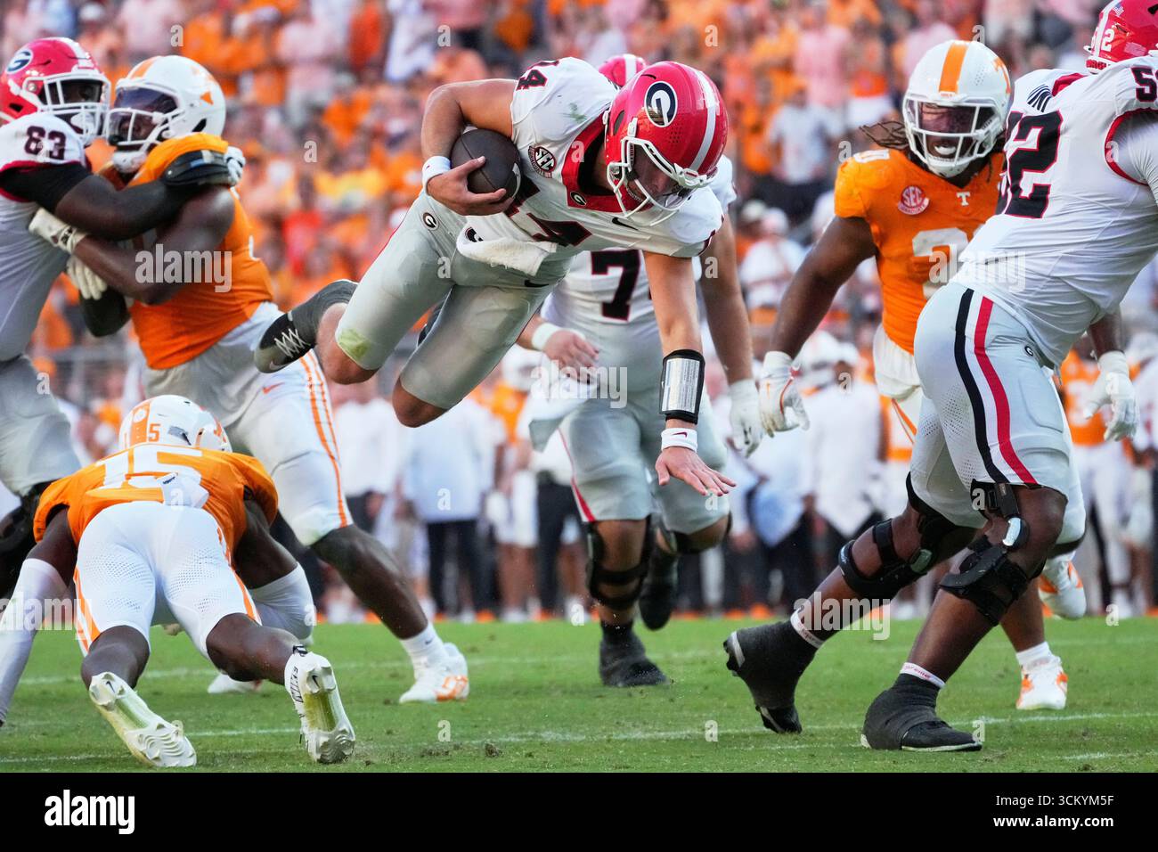Georgia quarterback Gunner Stockton (14) jumps over Tennessee defensive ...