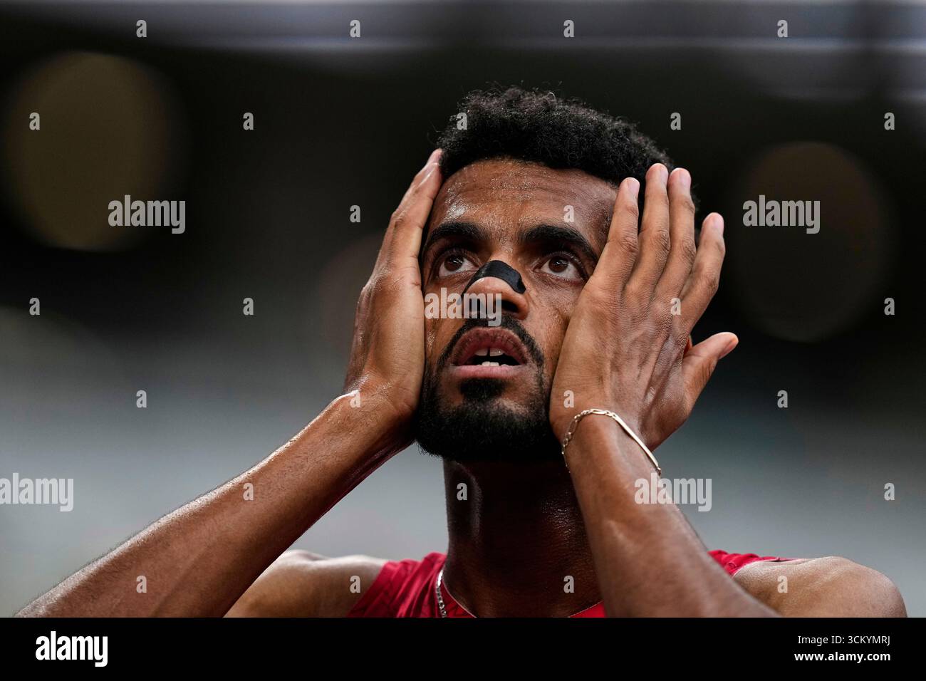 Morocco's Hafid Rizqy reacts after finishing a men's 1,500 meters heat ...