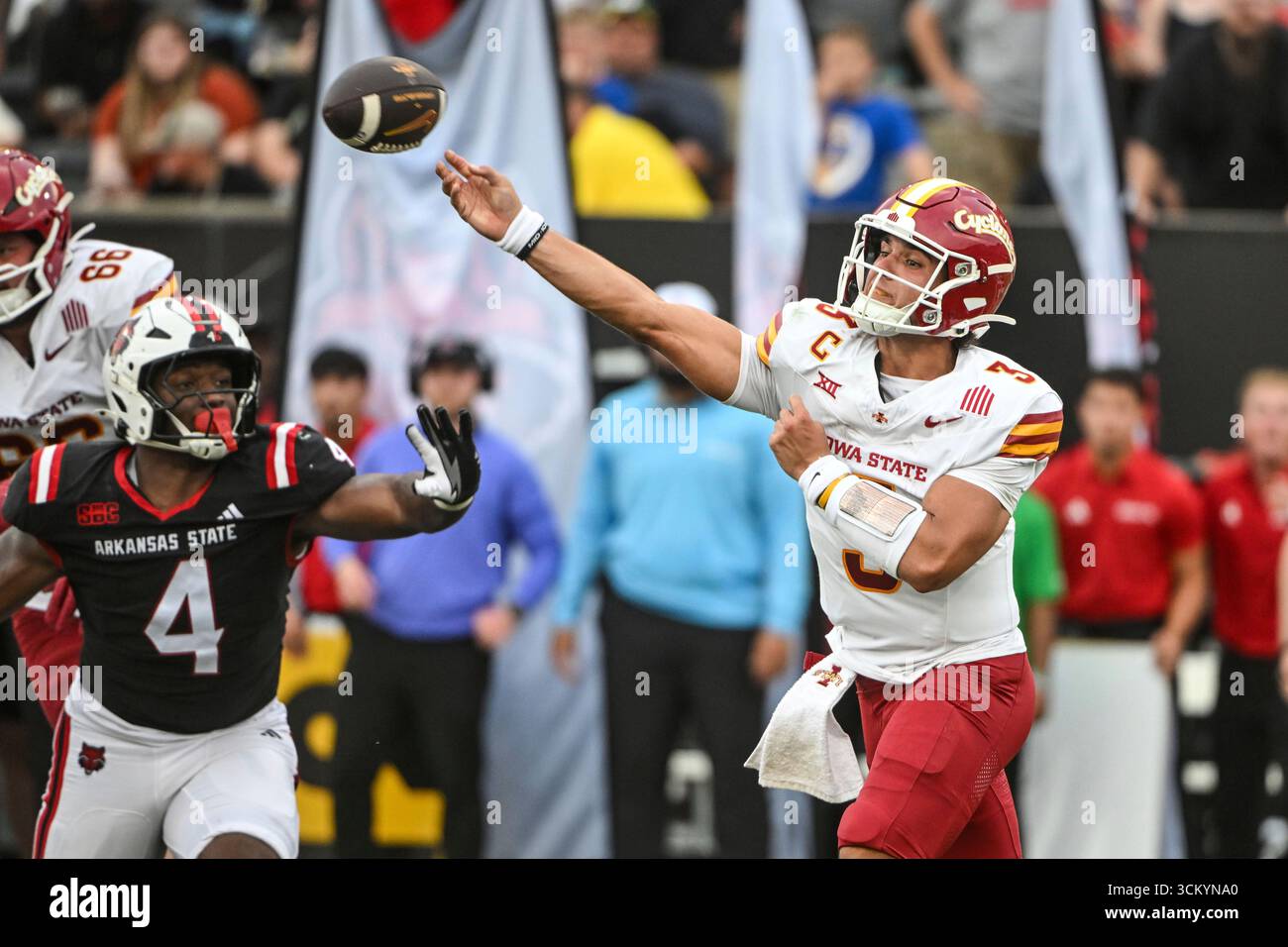 Iowa State quarterback Rocco Becht (3) throws a pass while under ...