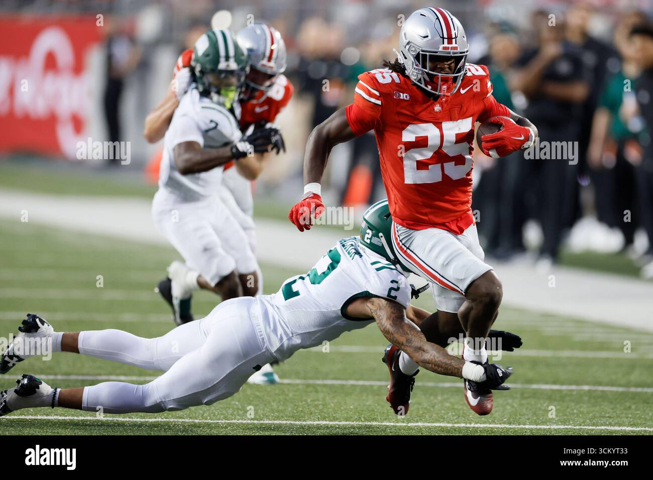 Ohio safety DJ Walker, left, tries to tackle Ohio State running back Bo ...