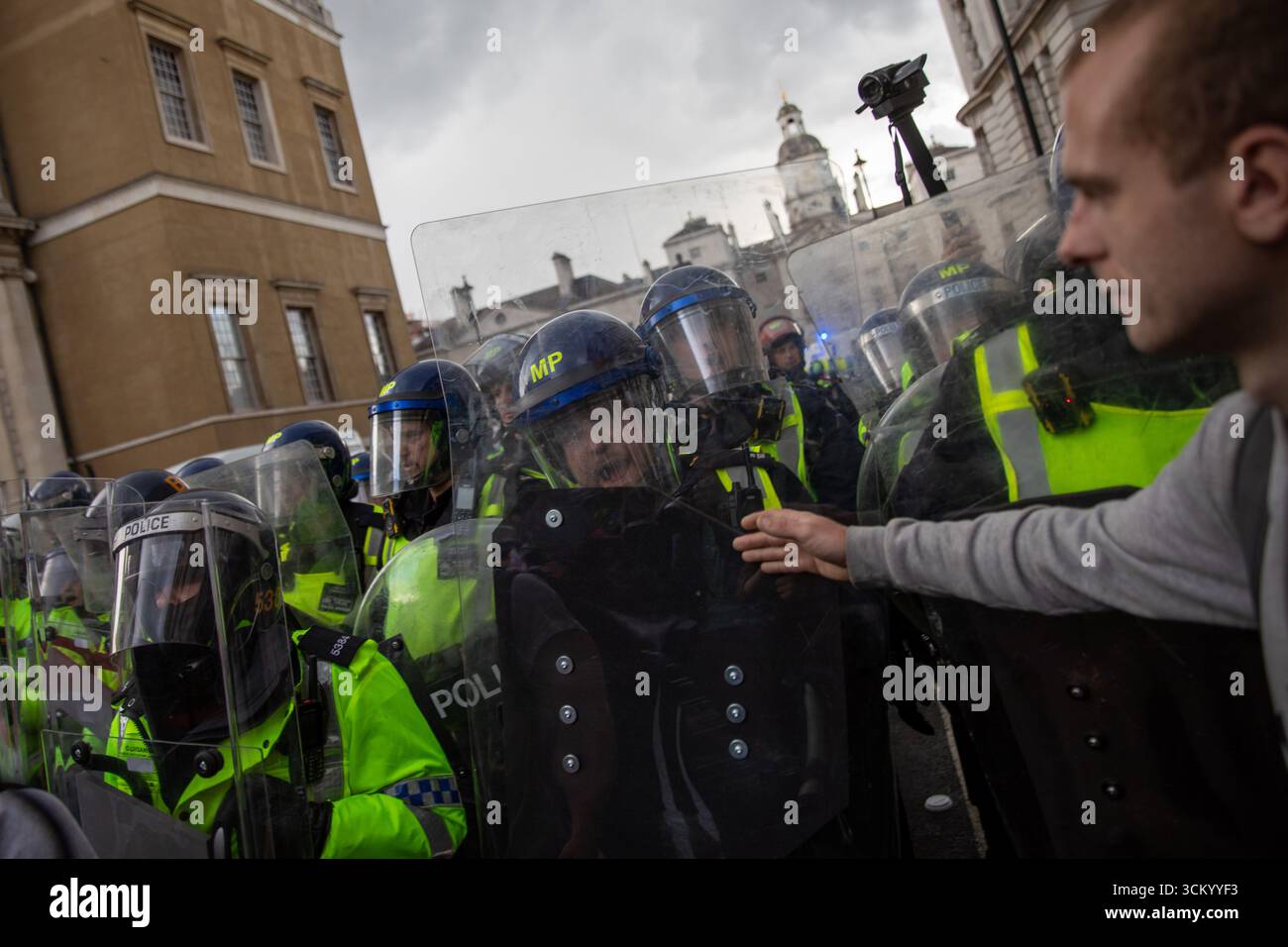 Members of the Metropolitan Police riot squad push back protestors. The ...