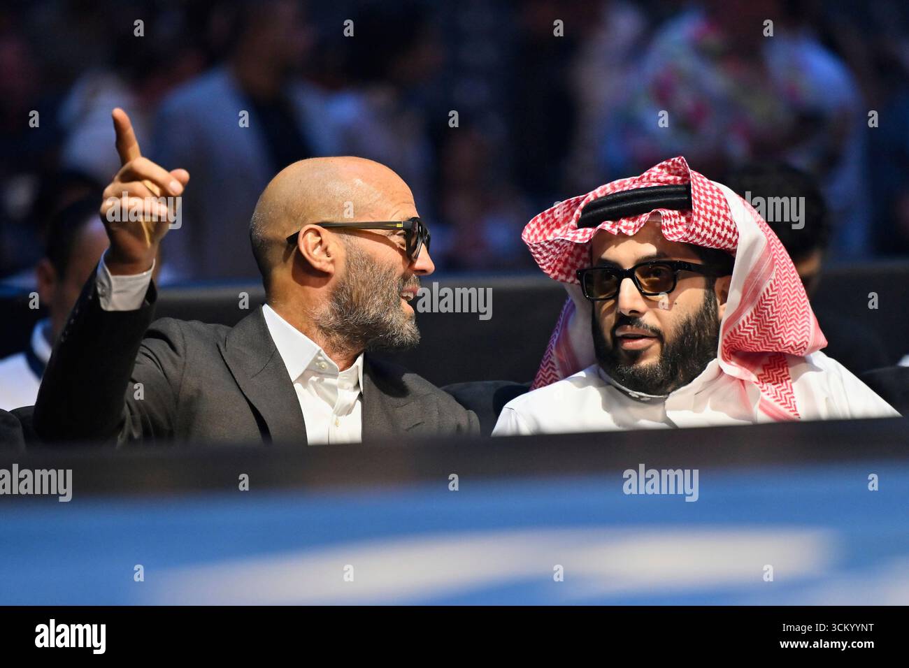 Actor Jason Statham, left, and Turki Alalshikha sit ringside before a ...