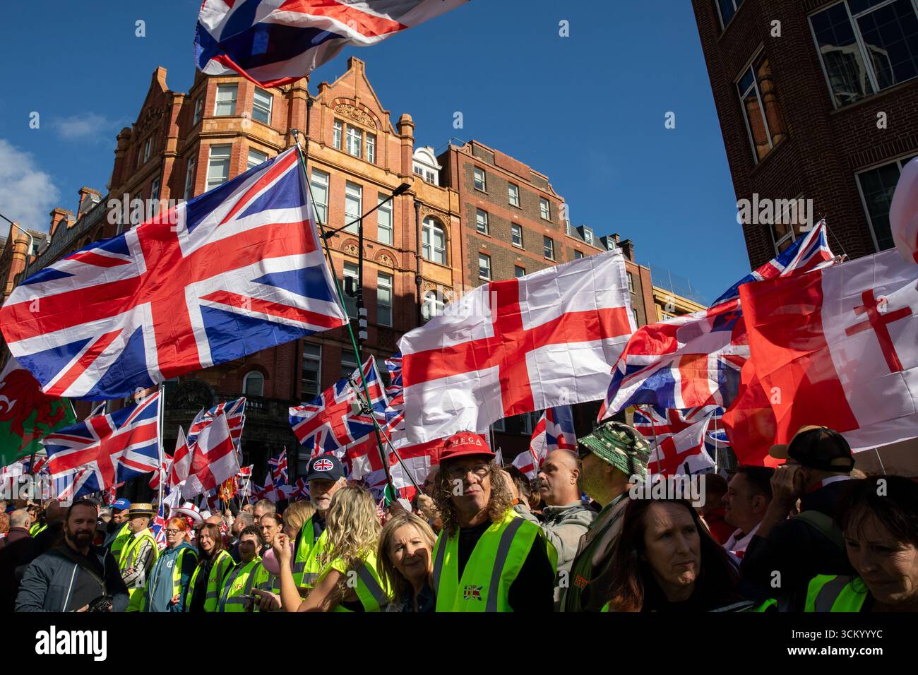 English and British flags are waved during a demonstration. The Unite ...