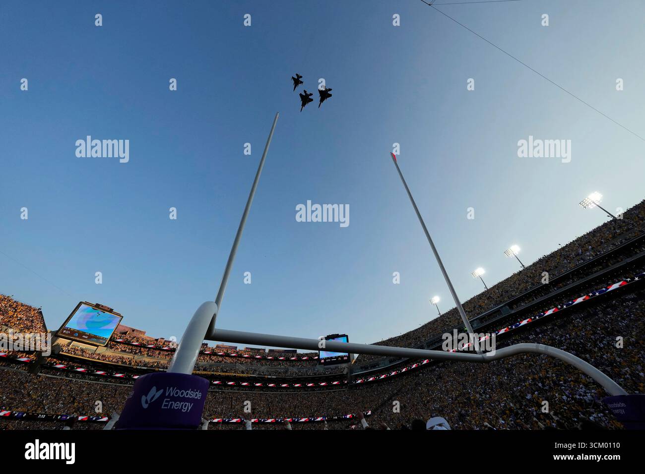 Military jets perform a flyover before an NCAA college football game ...