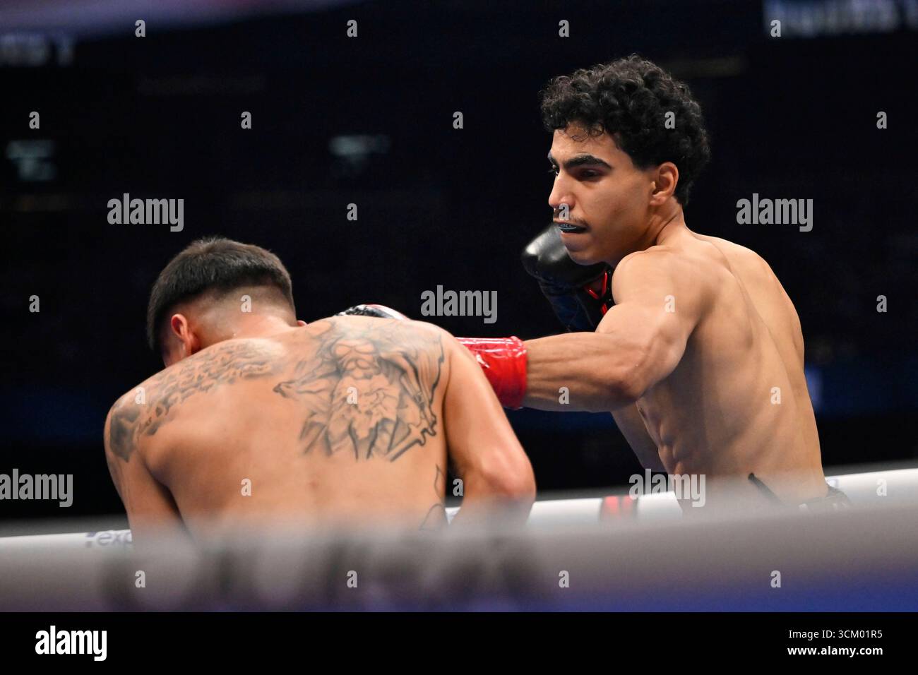 Mohammed Alakel, right, punches Travis Crawford during a lightweight boxing match in Las Vegas ...