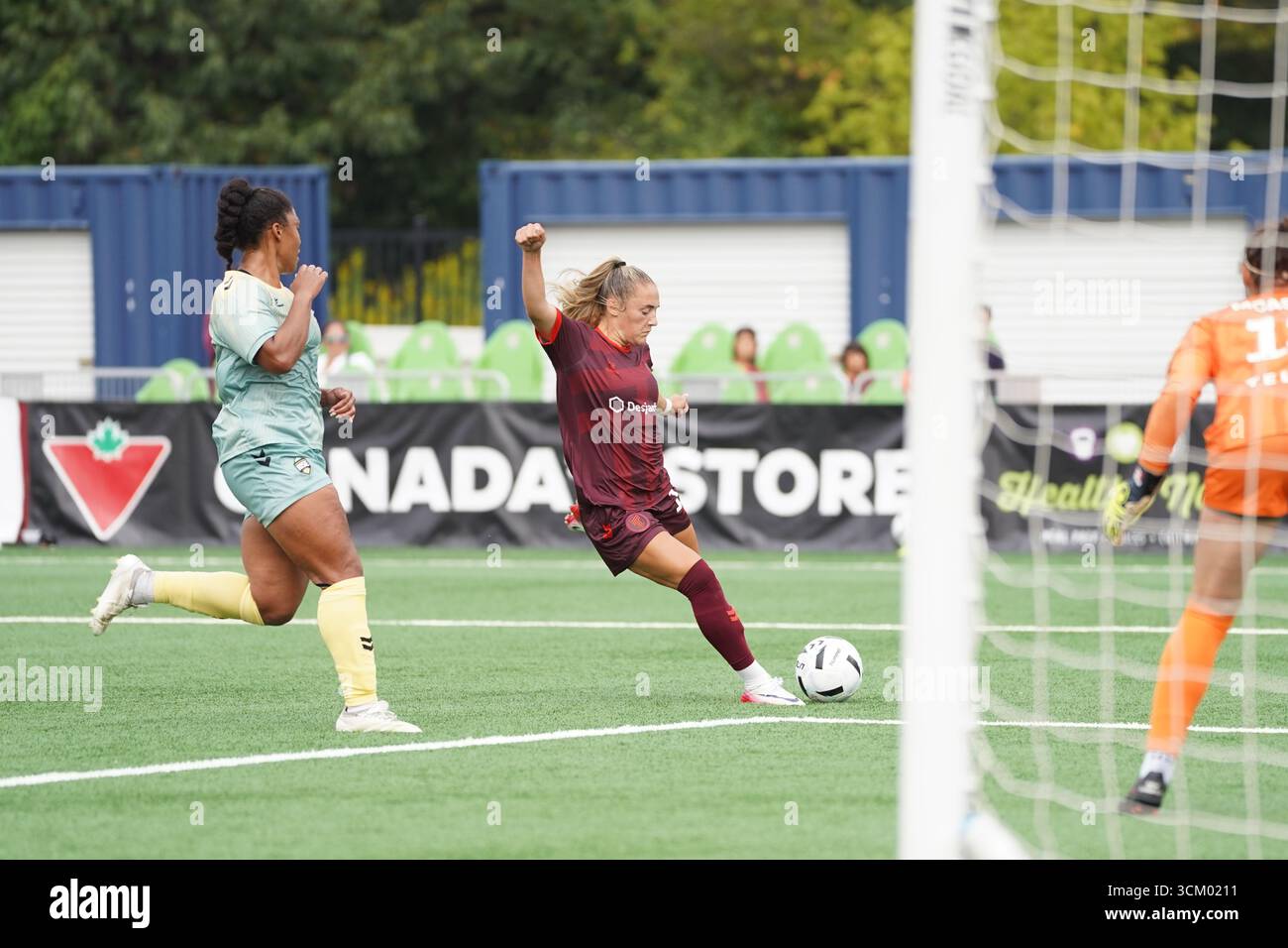 Kaylee Hunter #11 of AFC Toronto scoring a goal against goalie Morgan ...