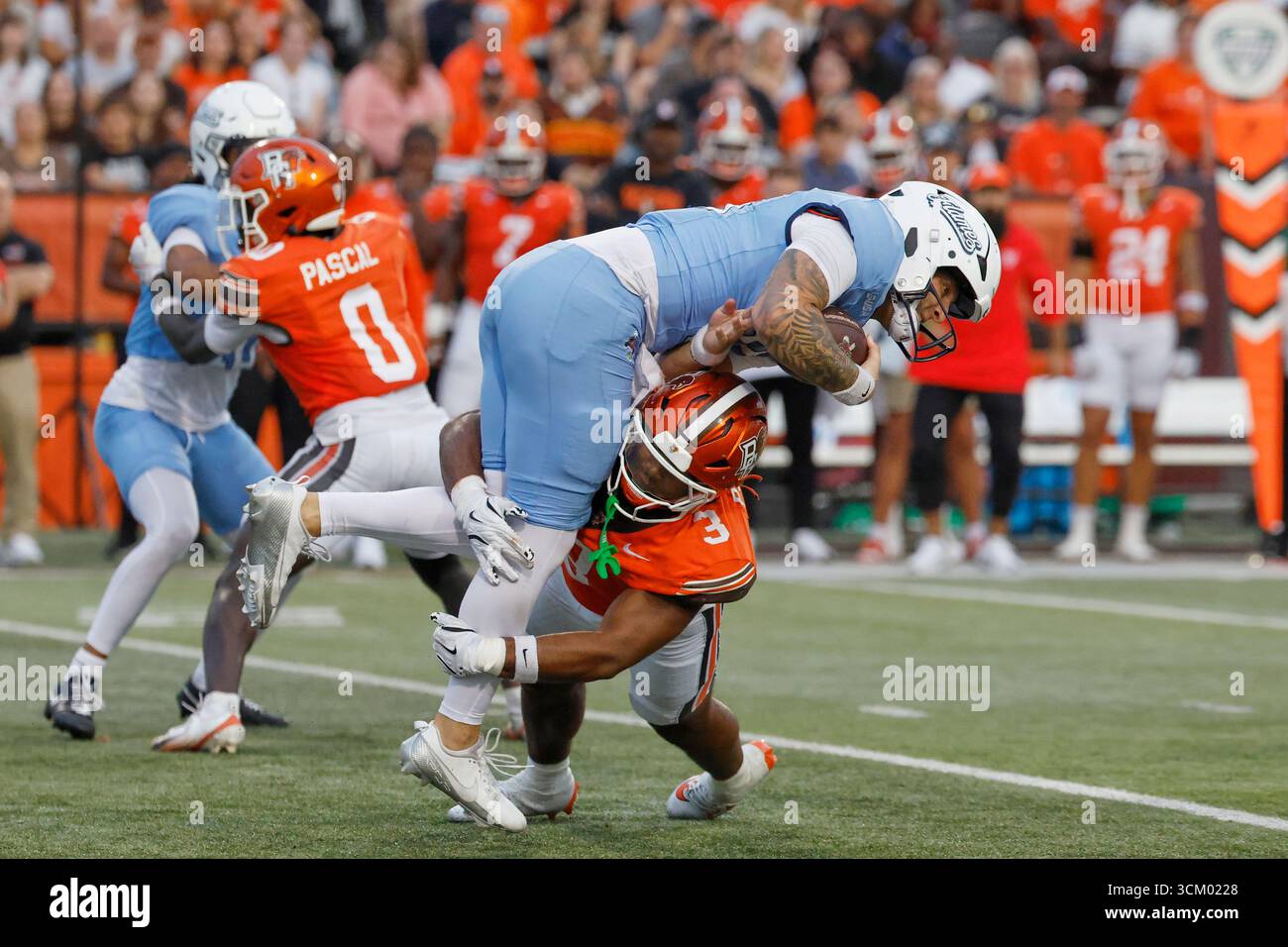 Liberty Flames quarterback Ethan Vasko (15) is tackled by Bowling Green ...