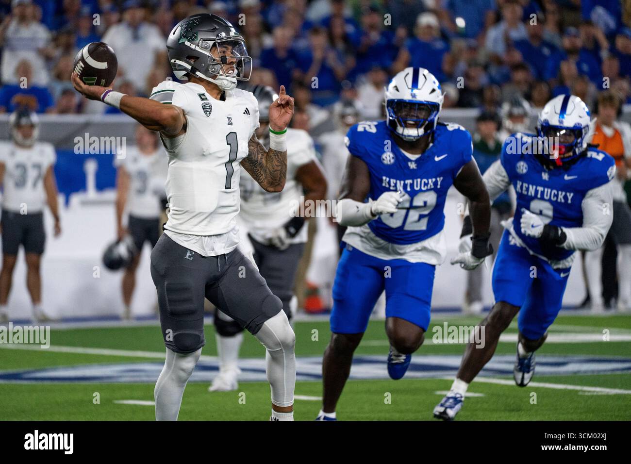 Eastern Michigan quarterback Noah Kim (1) scrambles to pass the ball in ...