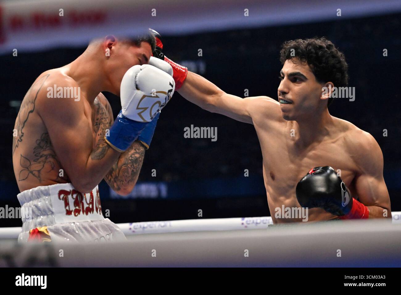 Mohammed Alakel, right, punches Travis Crawford during a lightweight ...