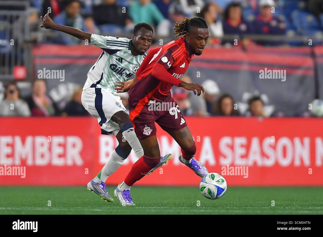 New England Revolution midfielder Alhassan Yusuf, left, and Toronto FC ...