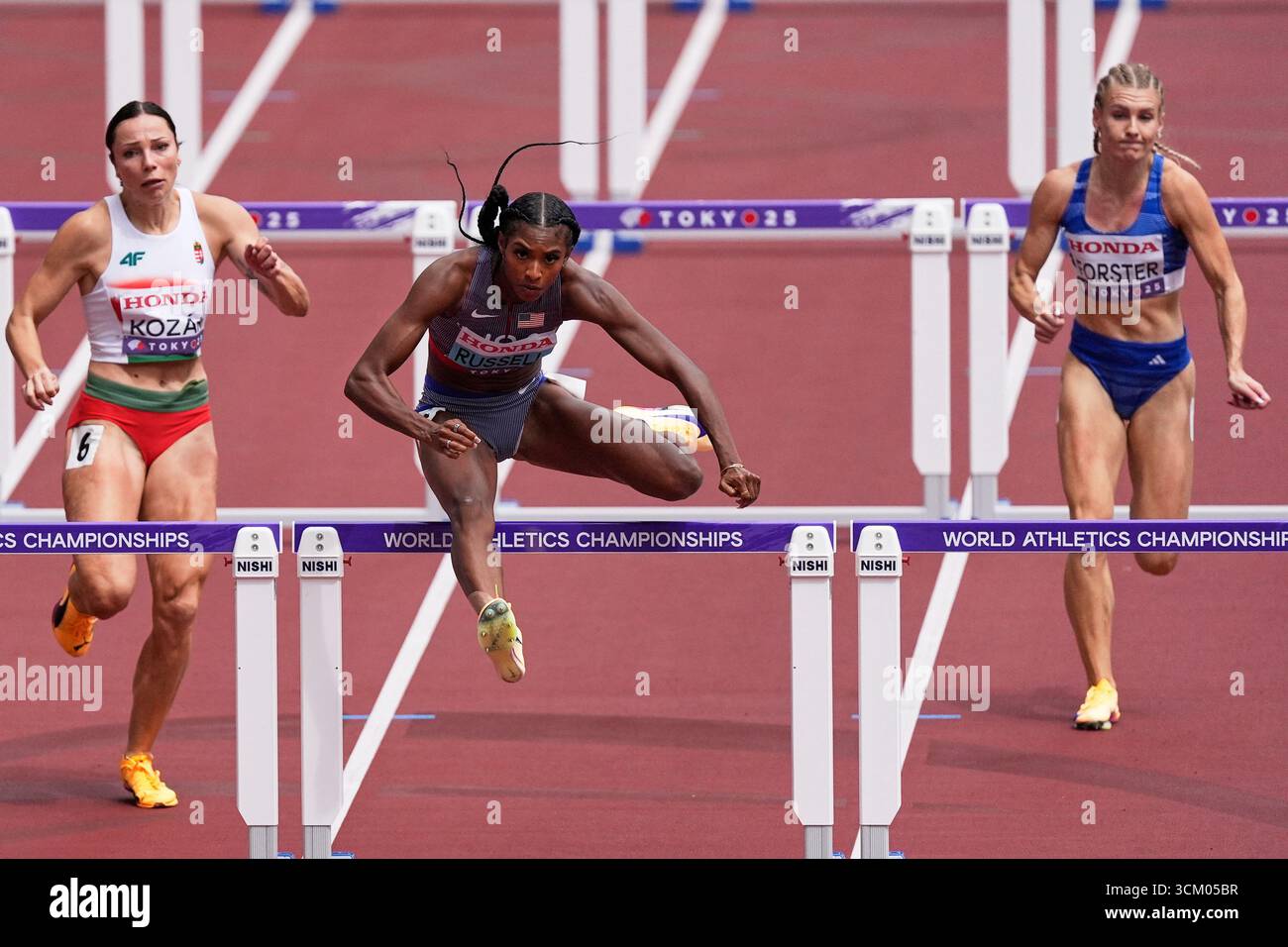 United States' Masai Russell, centre, competes in a women's 100 meters ...