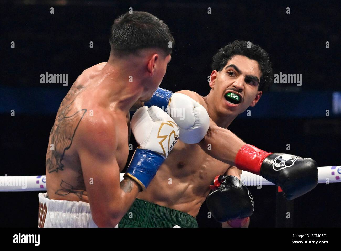 Mohammed Alakel, right, throws a punch at Travis Crawford during a lightweight boxing match in ...