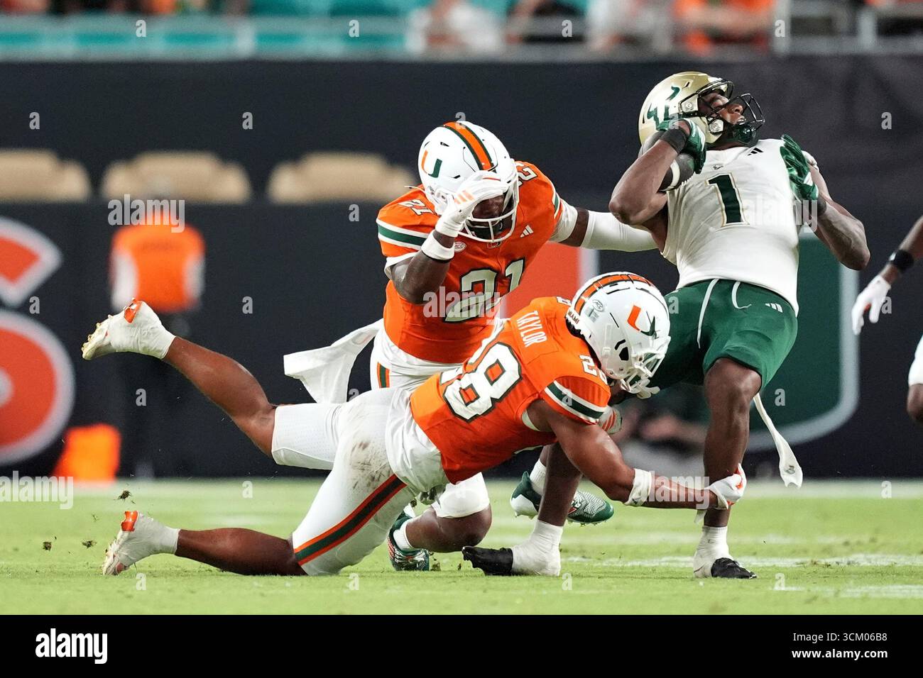 South Florida tight end Jonathan Echols (1) is taken down by Miami ...