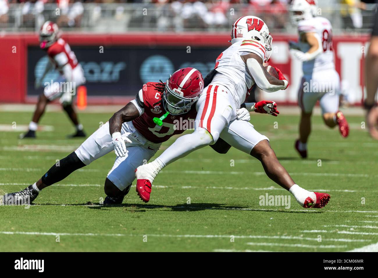 Alabama linebacker Deontae Lawson (0) tackles Wisconsin running back ...
