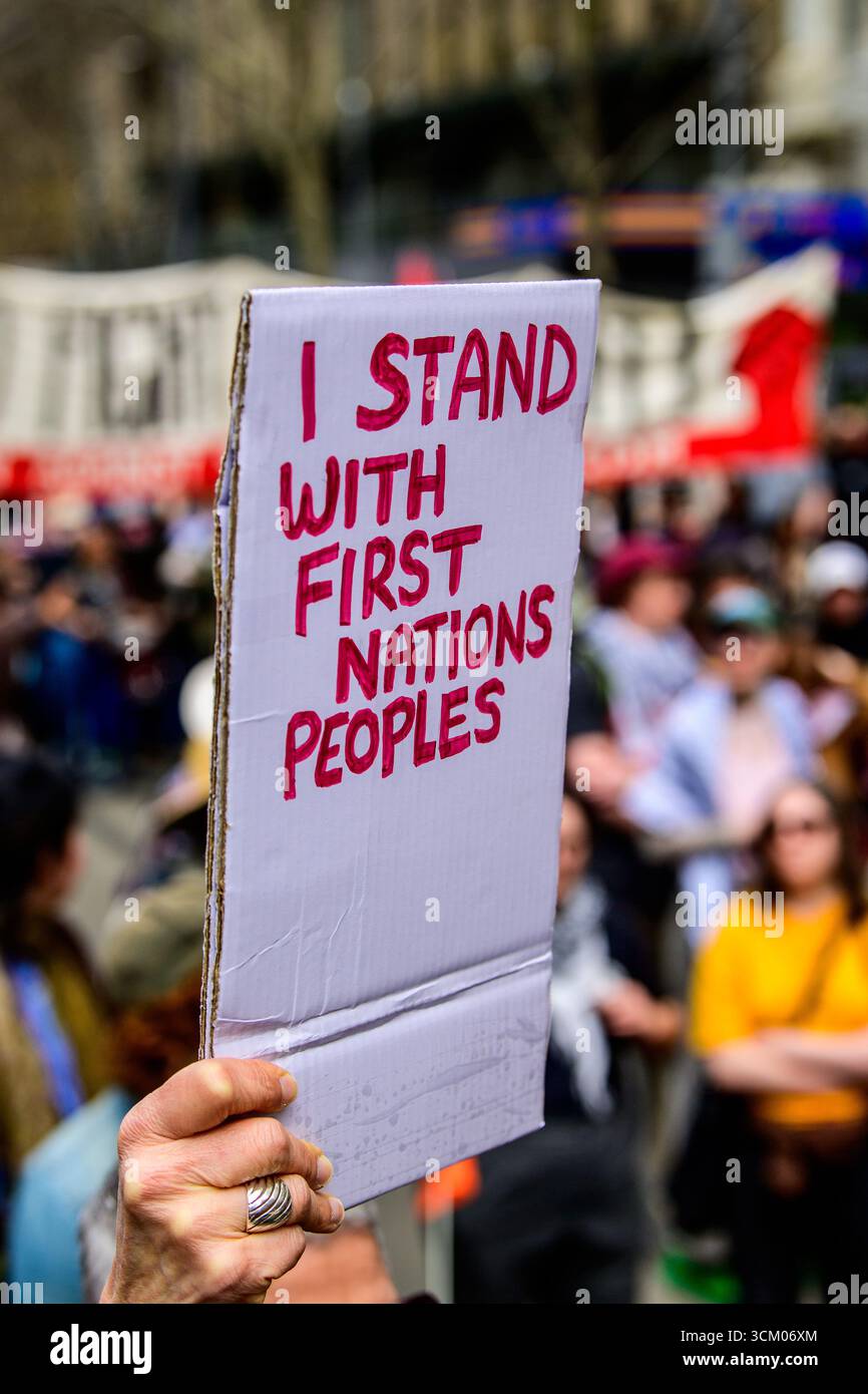 A protester holds a placard reading “I stand with First Nations Peoples ...