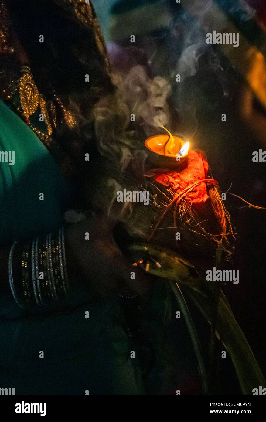 devotee holding sacred oil lamp offering on the occasion of chhath puja ...