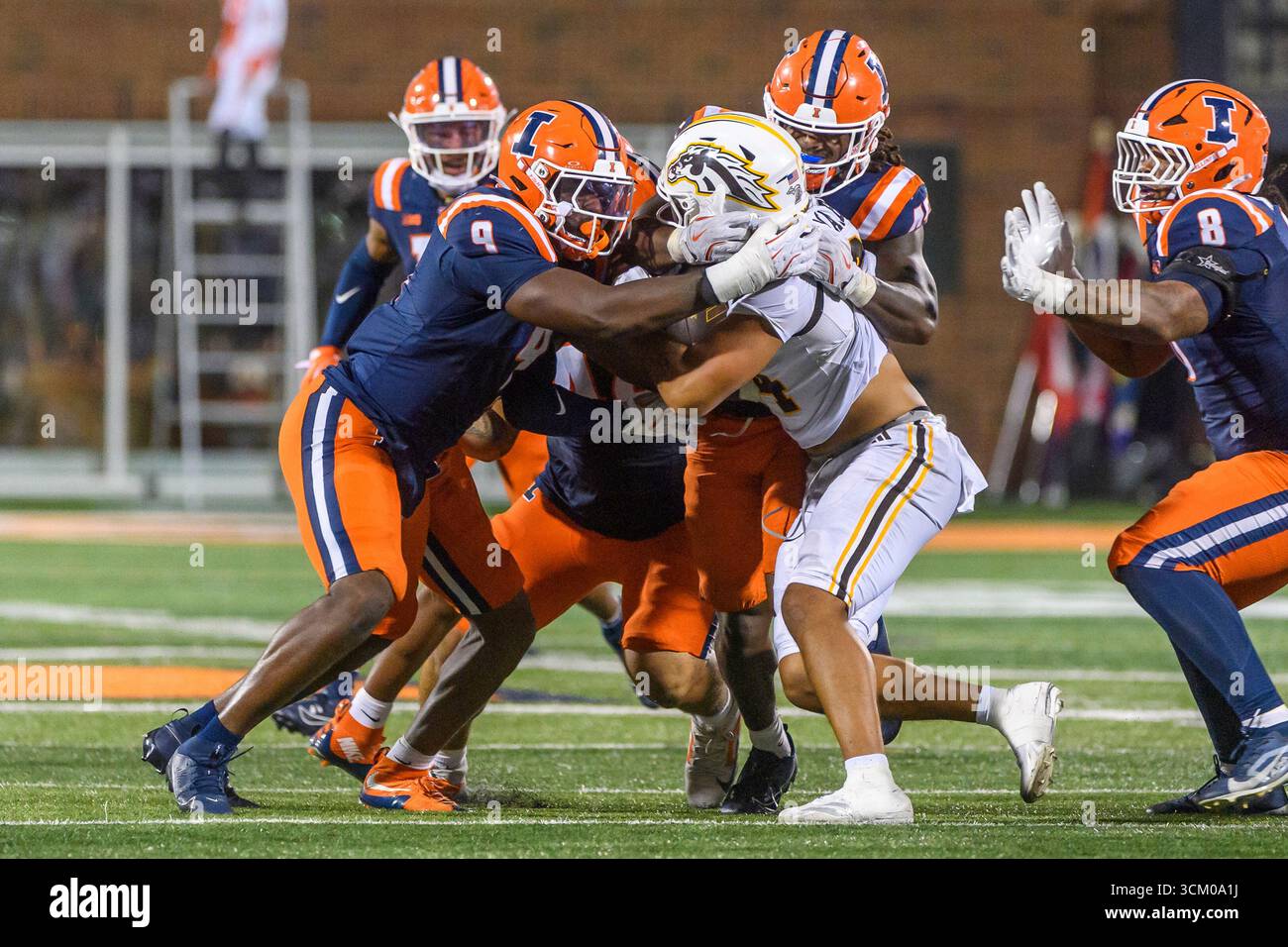 Western Michigan running back Cole Cabana (4) is stopped by Illinois ...