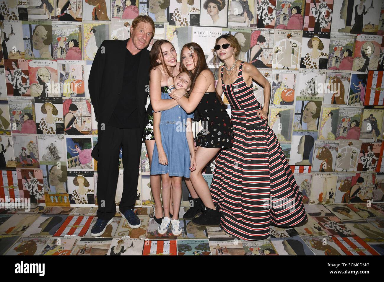 Eric Eisner (l) and Stacey Bendet (r) pose with their children as they ...