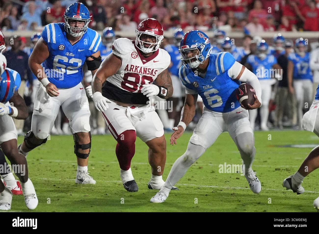 Mississippi quarterback Trinidad Chambliss (6) is pursued by Arkansas ...