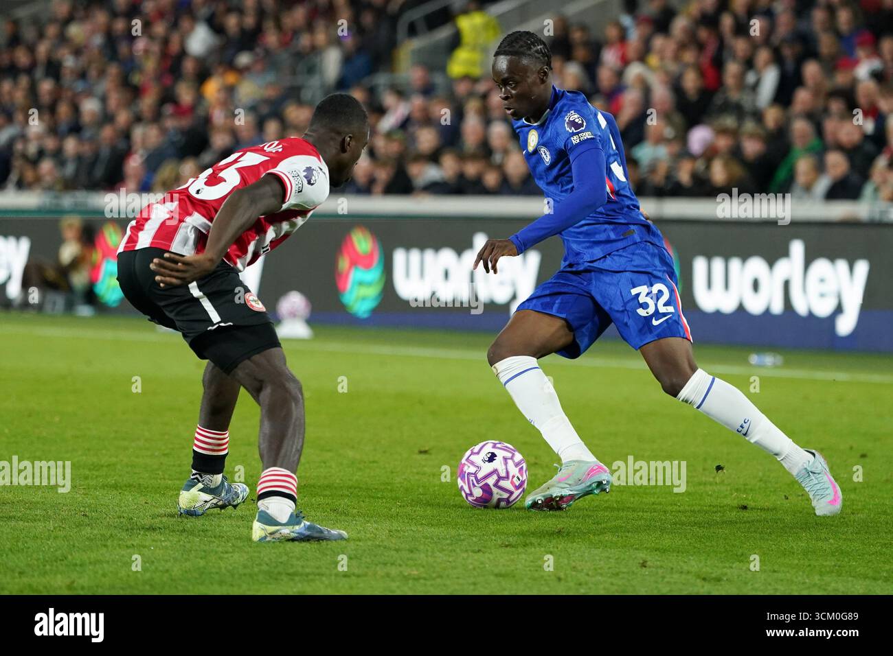 Tyrique George of Chelsea tries to get past Michael Kayode of Brentford ...