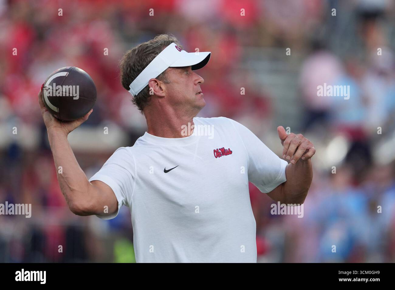 Mississippi head coach Lane Kiffin throws the football prior to the ...