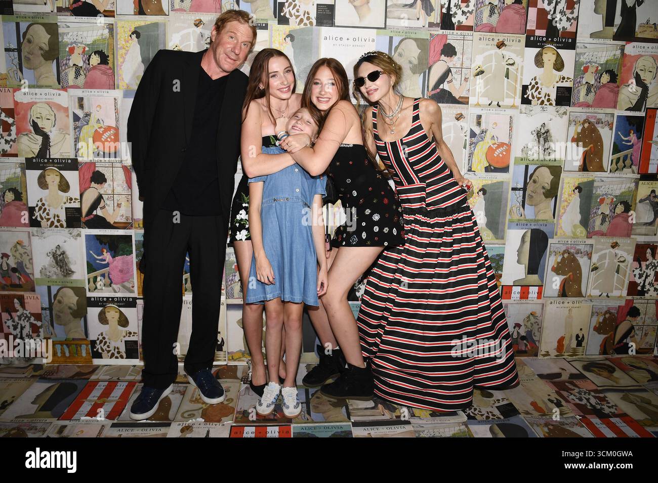 Eric Eisner (l) and Stacey Bendet (r) pose with their children as they ...