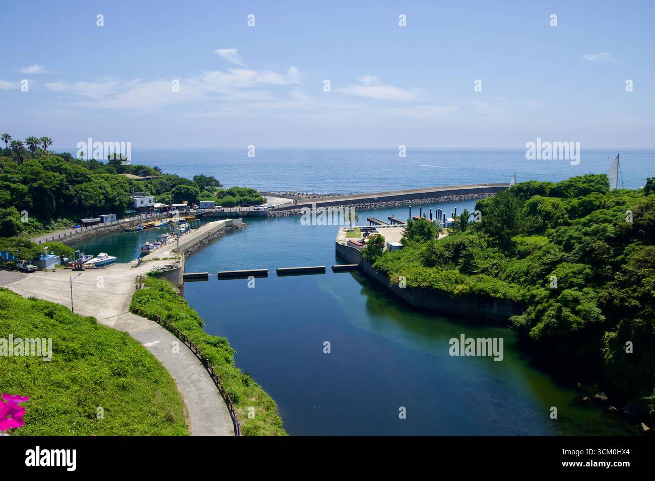 Daepo Port sits below the Jungmun Tourist Complex, where a narrow inlet ...