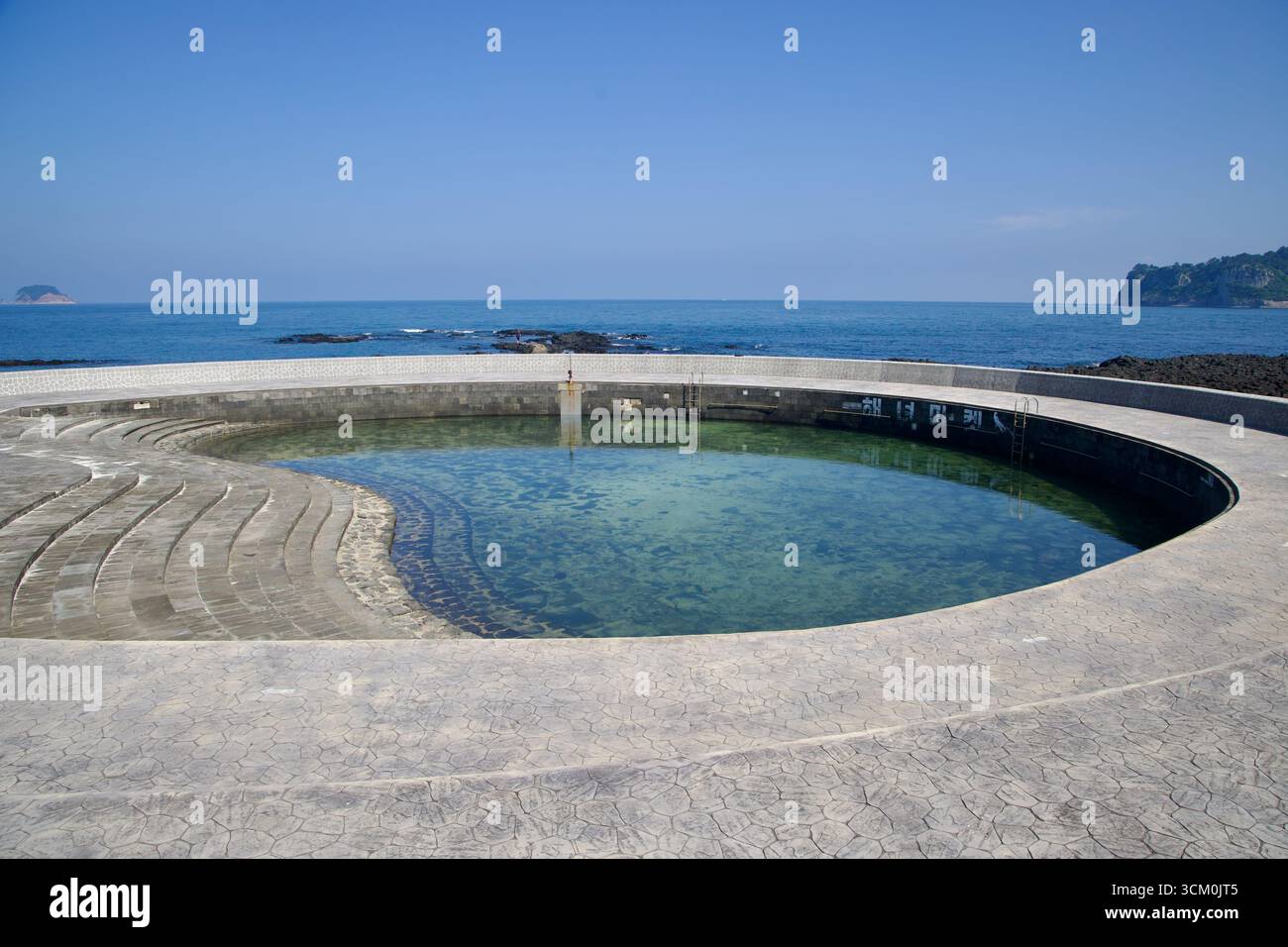 A circular seawater pool built along the Beophwan coast reflects the ...