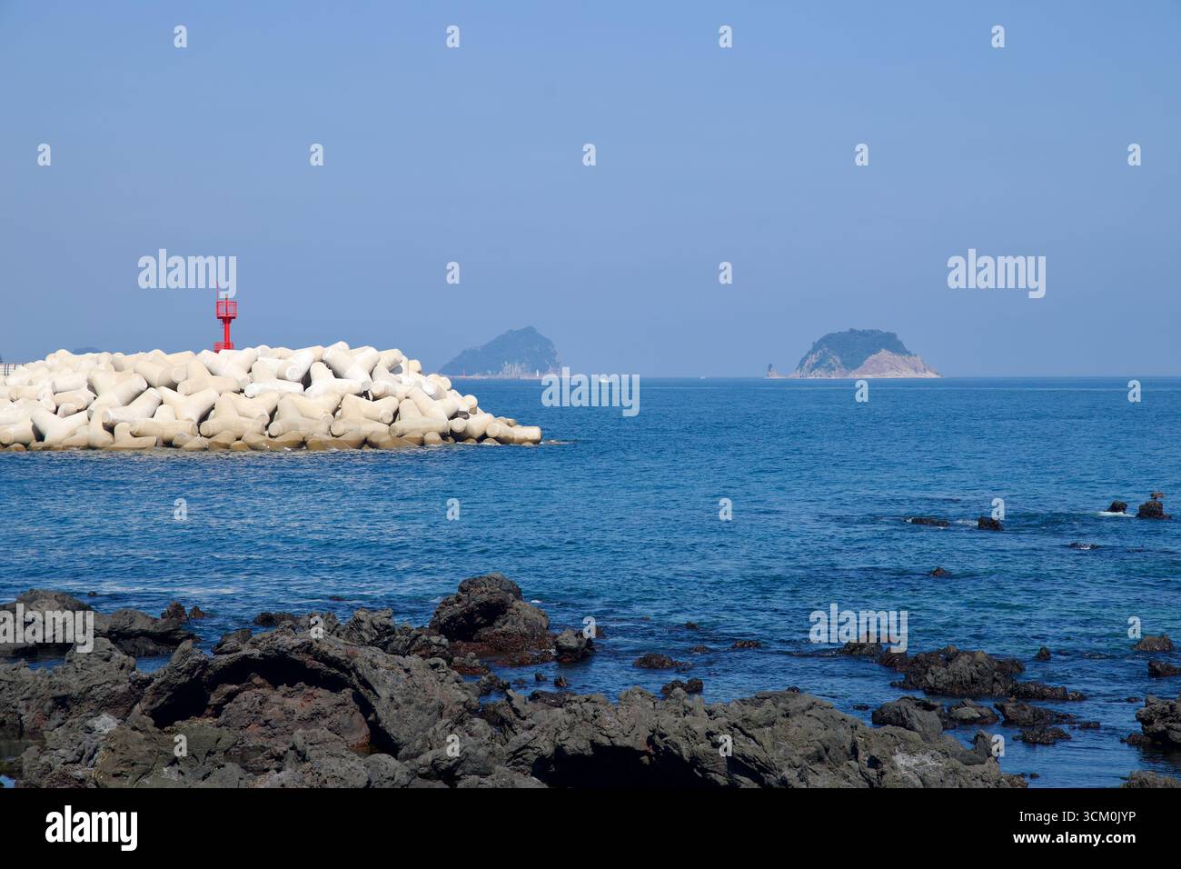 White tetrapods form a breakwater at Beophwan Harbor, with a red ...