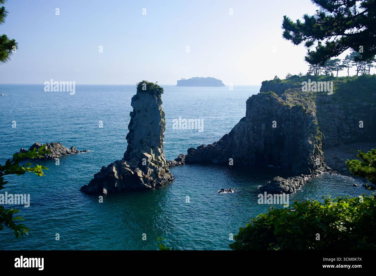 The iconic Oedolgae Rock sea stack stands beside coastal cliffs and a ...