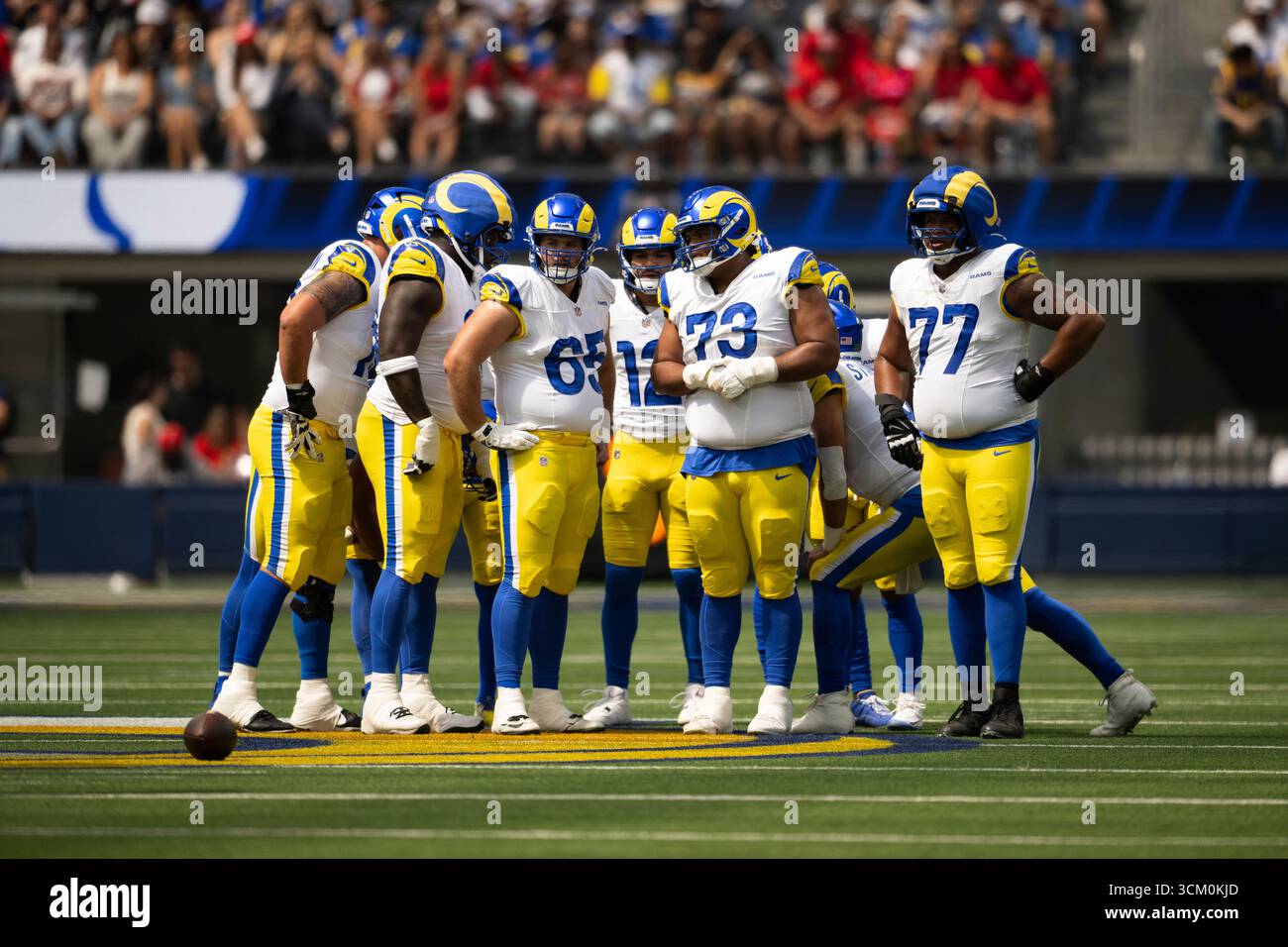 Los Angeles Rams players huddle during an NFL football game against the ...