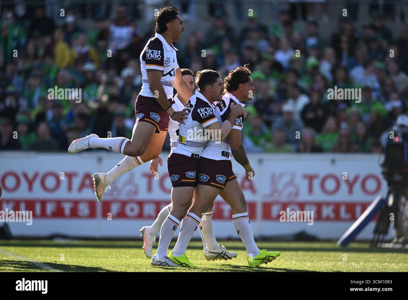 Kotoni Staggs of the Broncos celebrates with team mates after scoring a ...