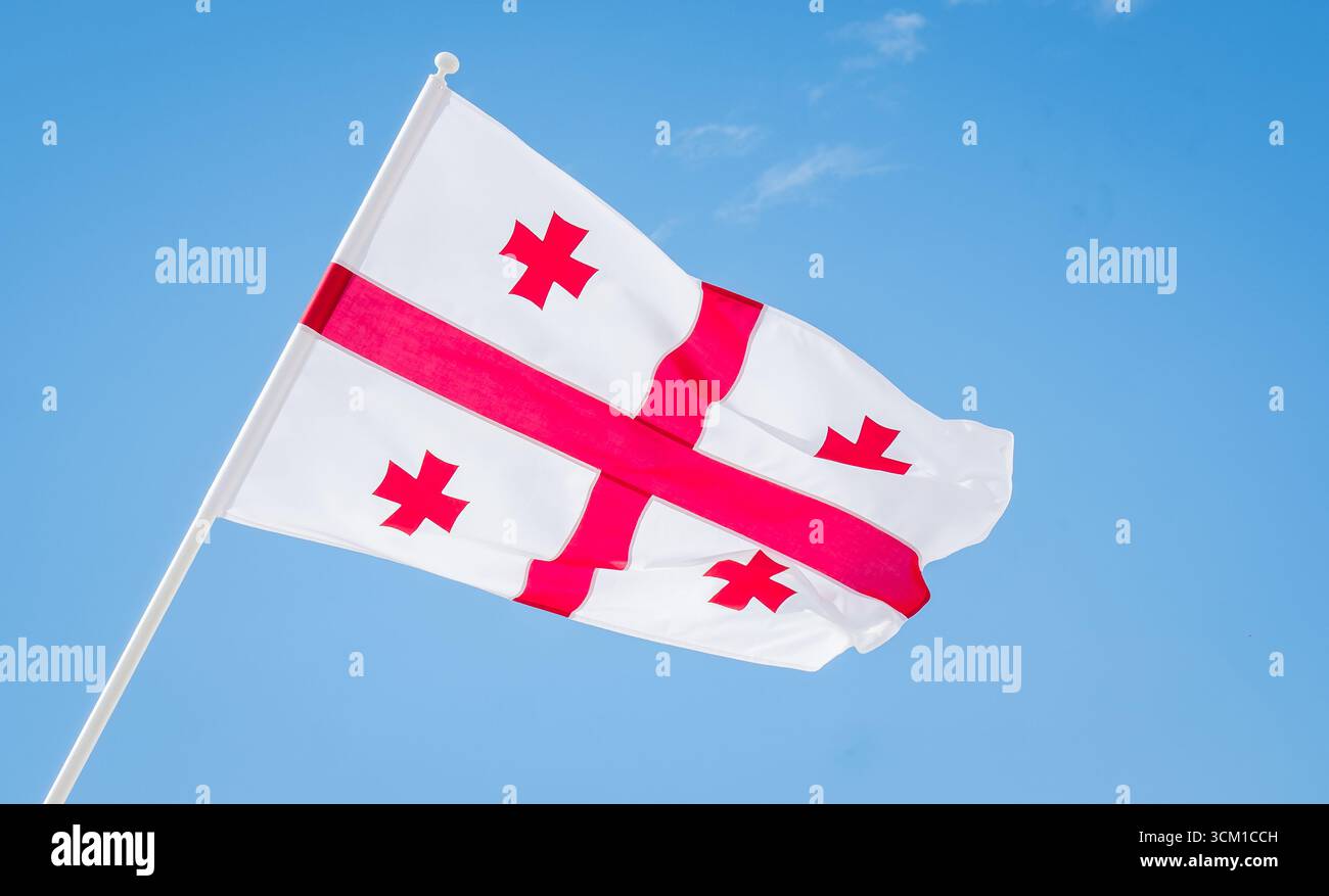 The national flag of Georgia, featuring the red cross of St George ...
