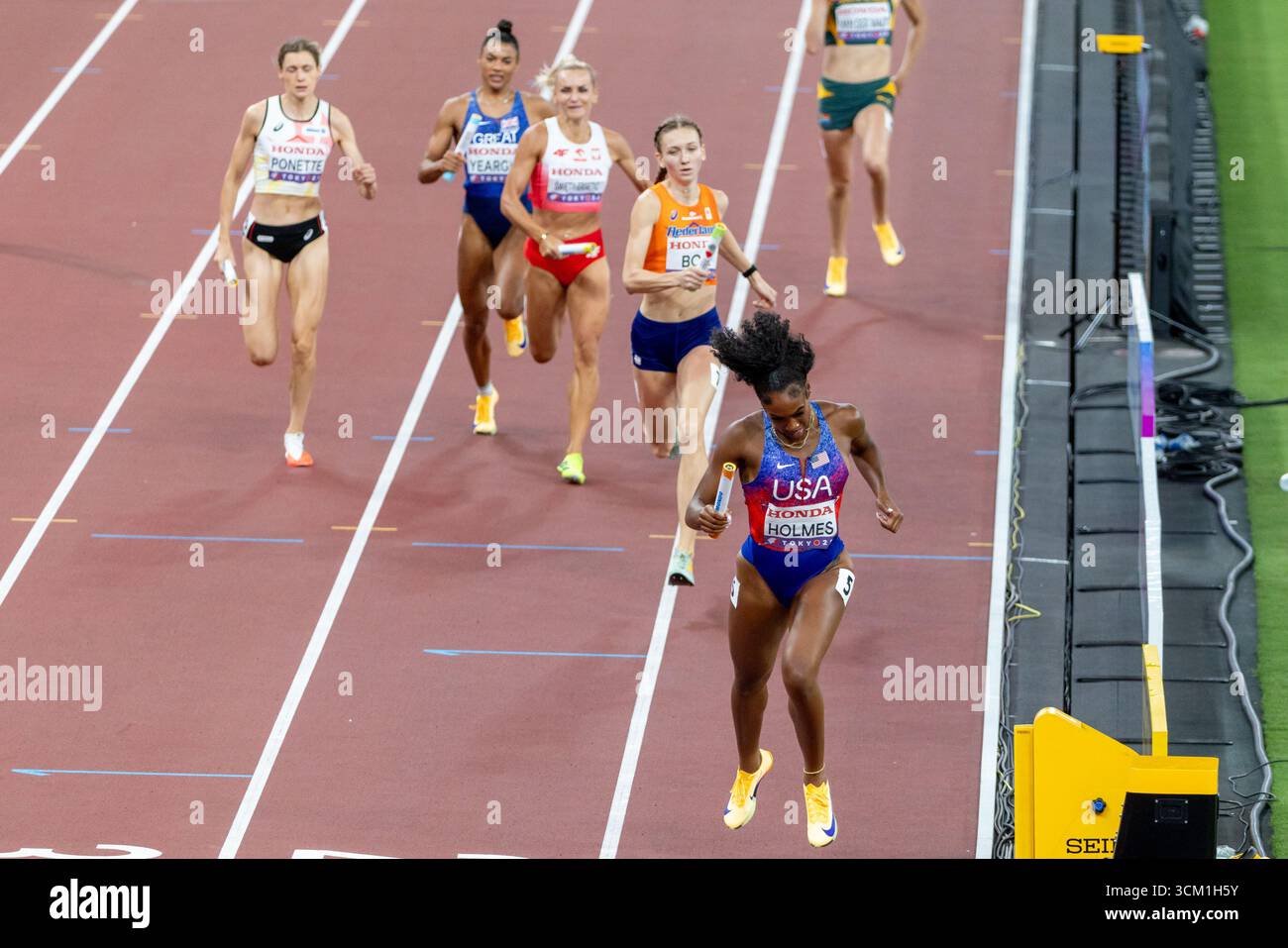 Alexis Holmes (USA) crosses the finish line as team USA wins the mixed ...