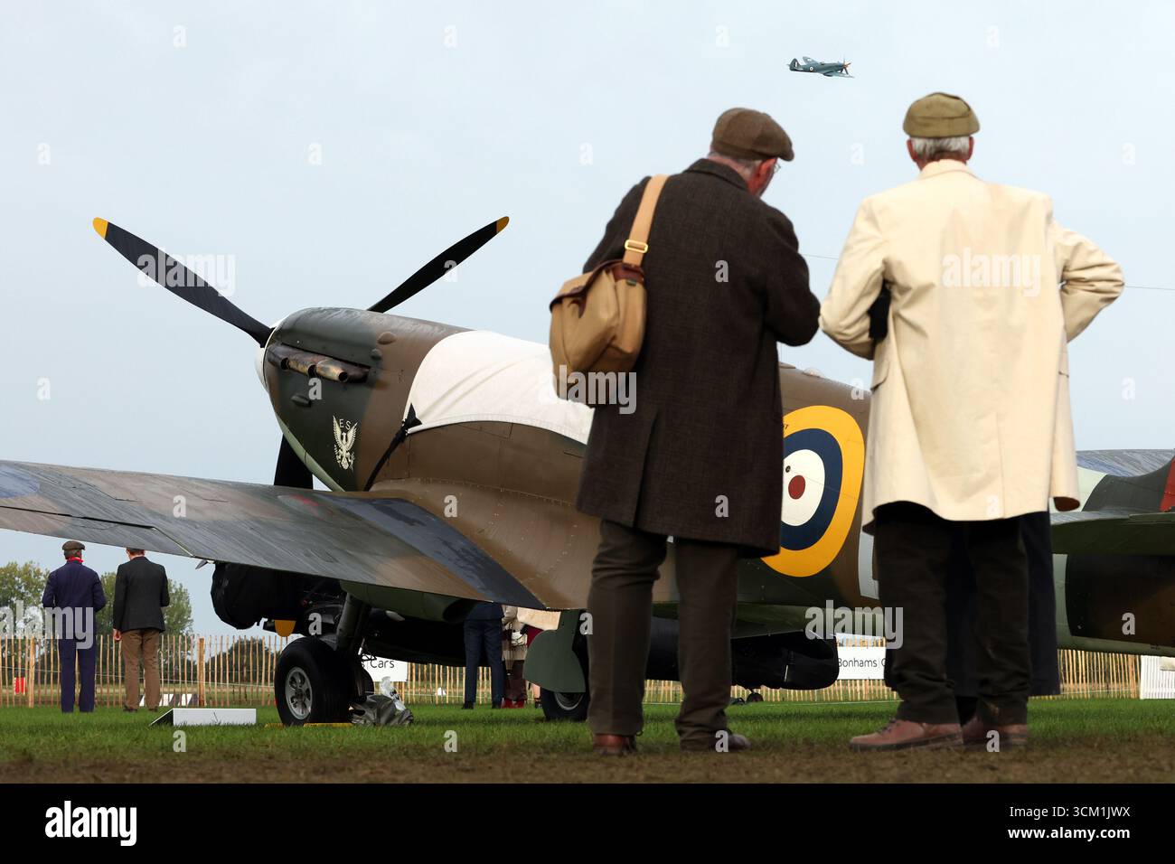 Racemeet goers watch a Spitfire display at day-three of the Goodwood ...