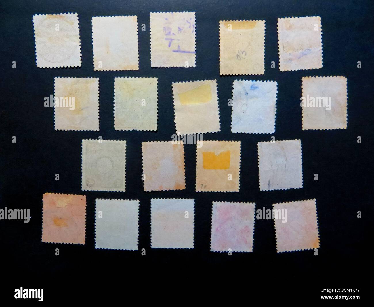 Collection of vintage postage stamps displayed with their reverse sides ...