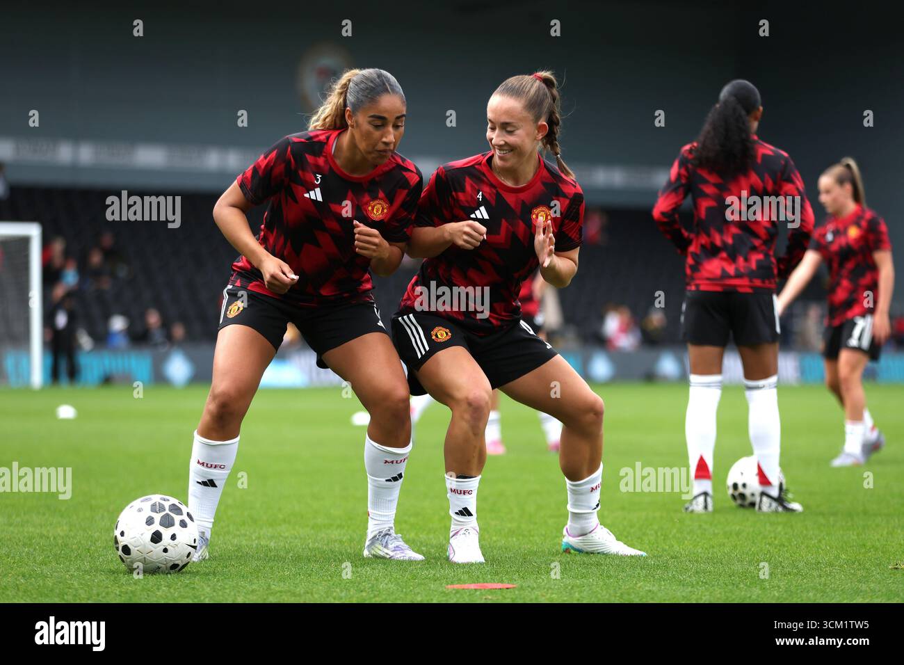 Manchester United's Gabrielle George (left) and Maya Le Tissier warming ...