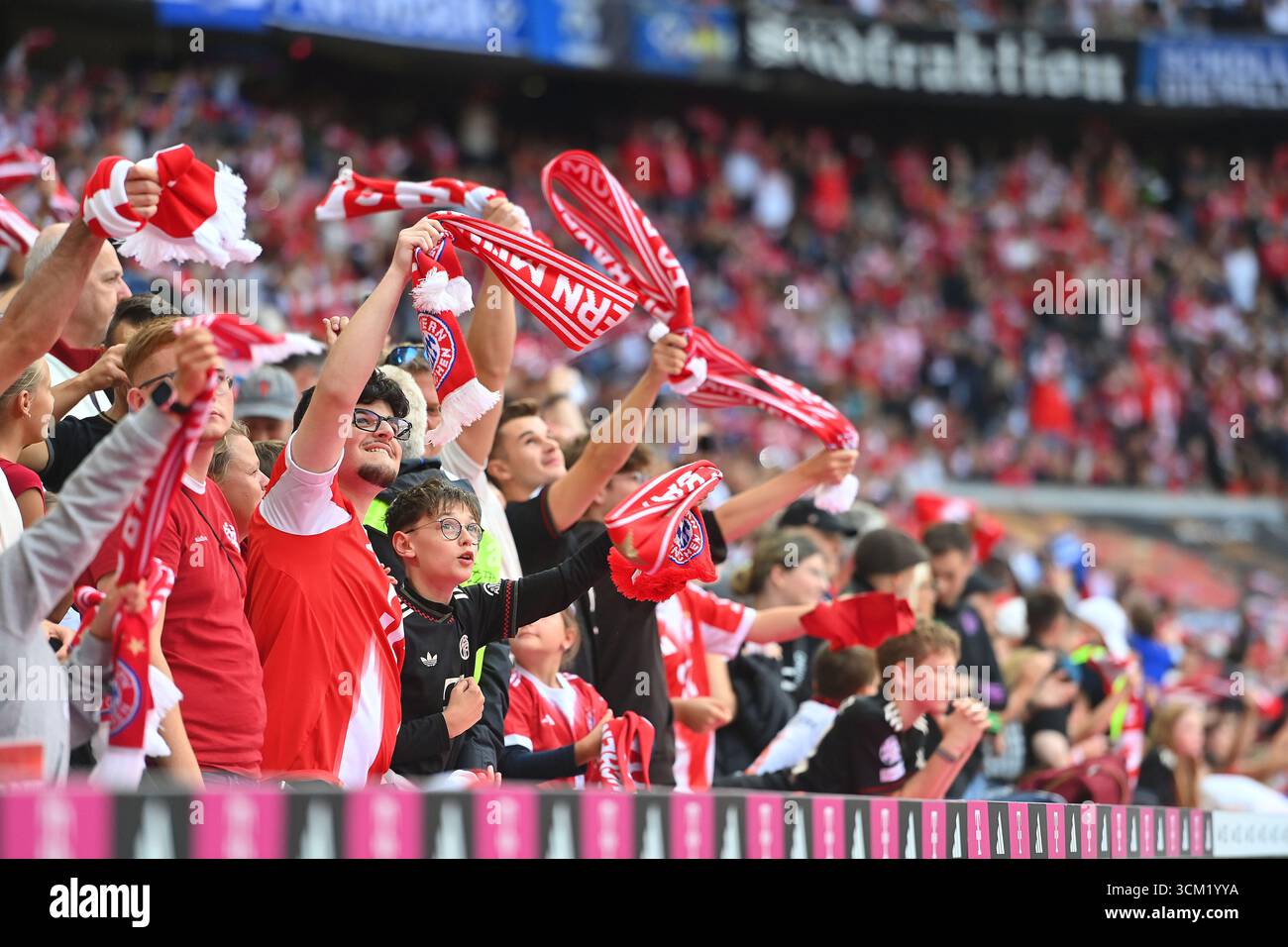 Bayern fans, football fans wave their scarves, fan scarves. Football 1 ...