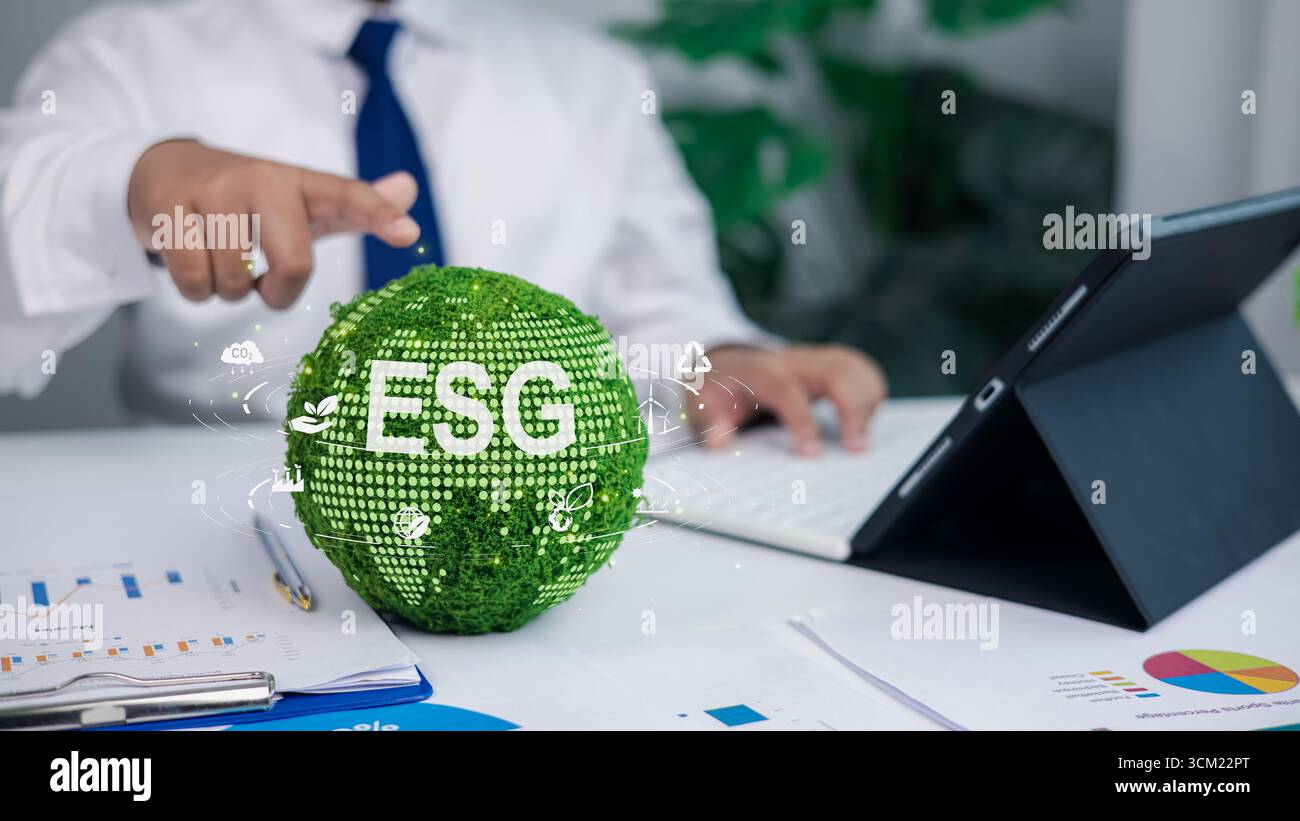 Business professional analyzing ESG strategy with green digital globe ...