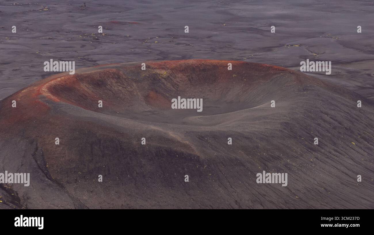 Aerial perspective of a volcanic crater in Iceland, with reddish rim ...