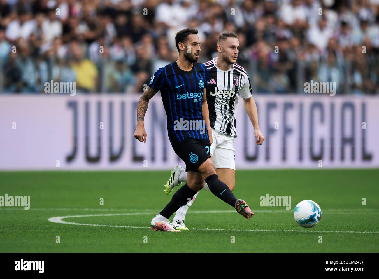 Hakan Calhanoglu of FC Internazionale competes for the ball with Teun ...