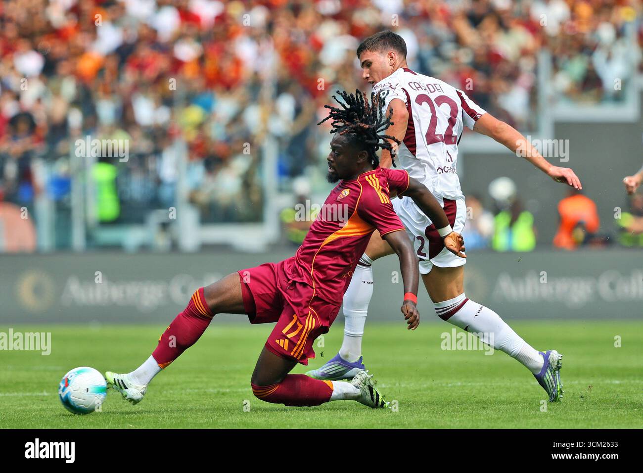 Rome, Italy. 14th Sep, 2025. Manu Kone' of Roma vies for the ball with ...