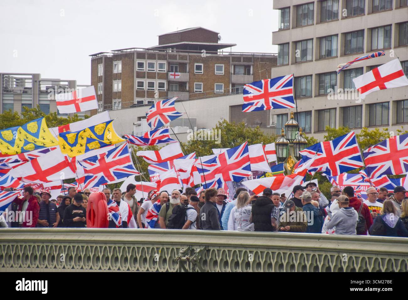 London, UK. 13th September 2025. Far-right protesters pass along ...